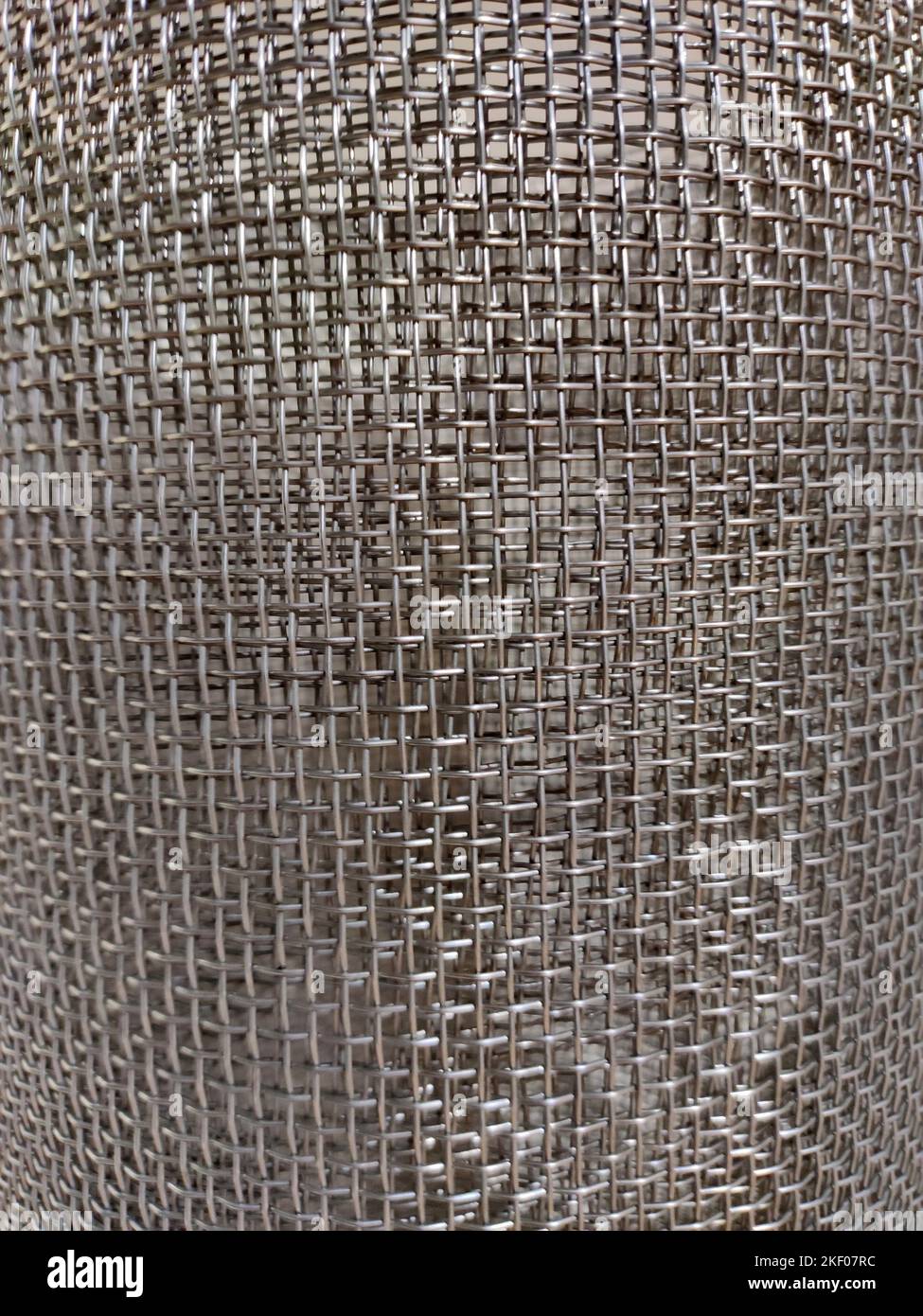 Close-up of stainless steel wire mesh. Woven in pattern, shiny metallic ...