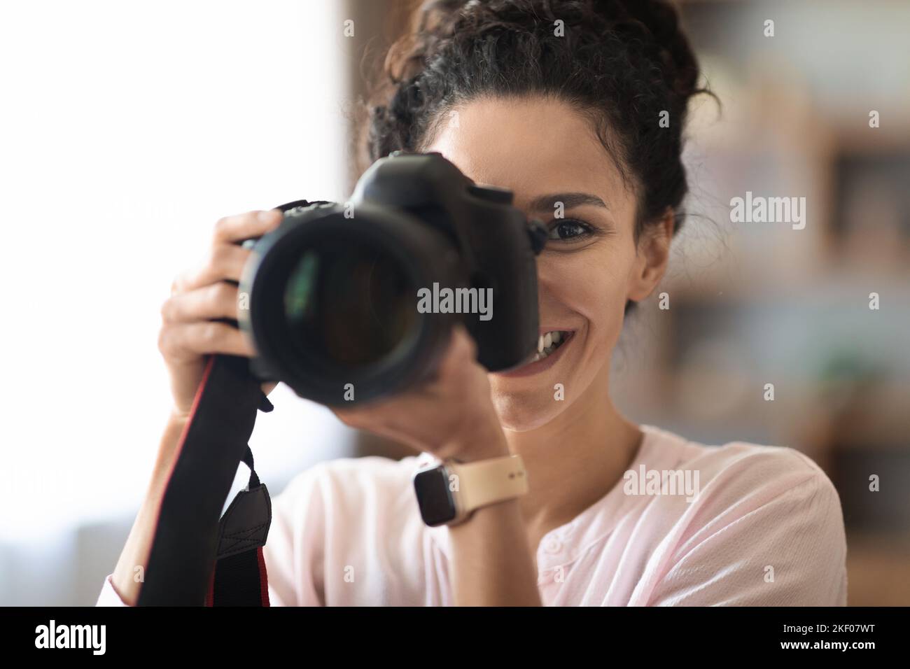 photo of Female photographer with DSLR at home or studio Stock Photo ...