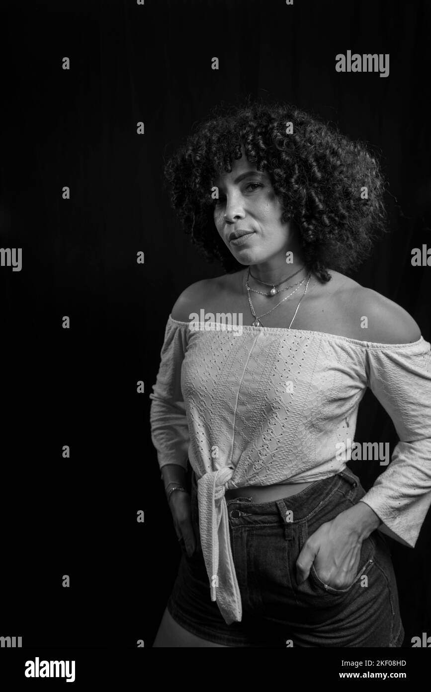 Black and white portrait of beautiful woman against black background ...