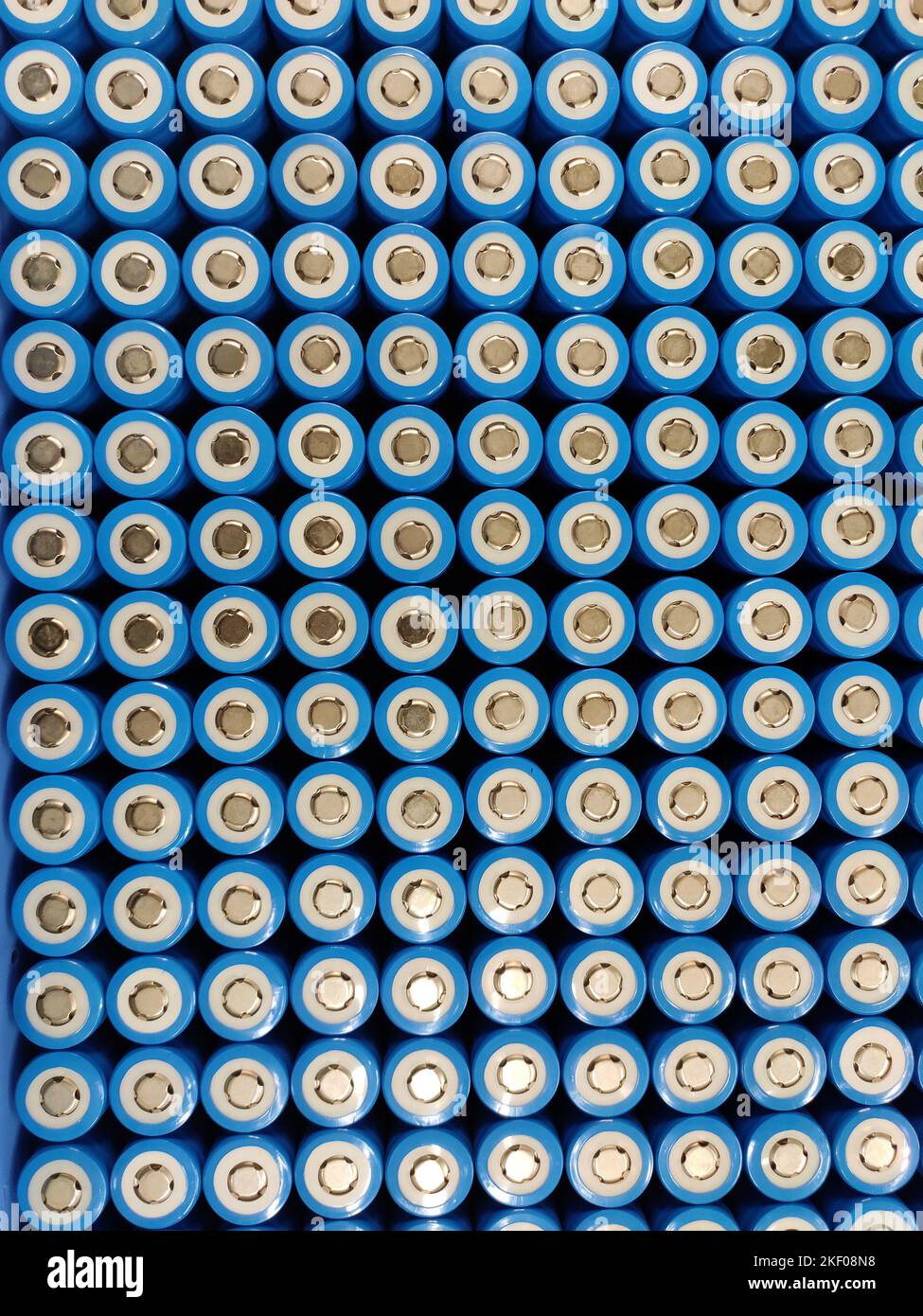 A close-up image of a grid of cylindrical lithium-ion batteries. The ...