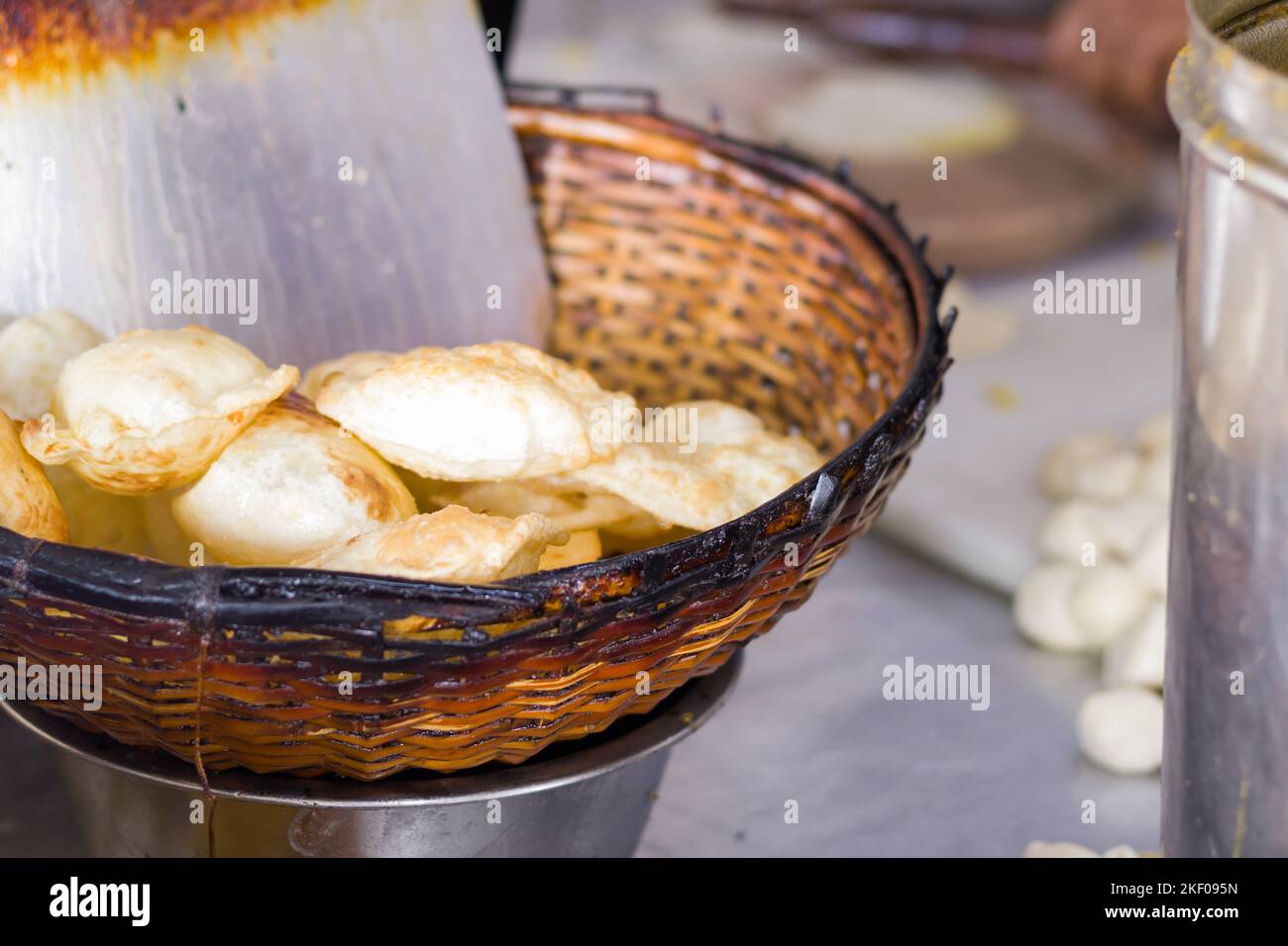 poori or puri or luchi kept in a cane basket.traditional indian ...