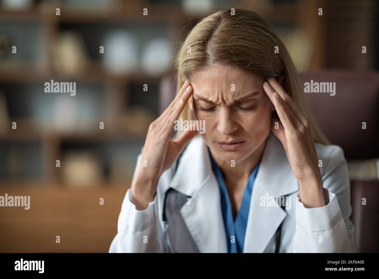 Closeup Shot Of Stressed Doctor Lady Suffering Headache At Workplace ...