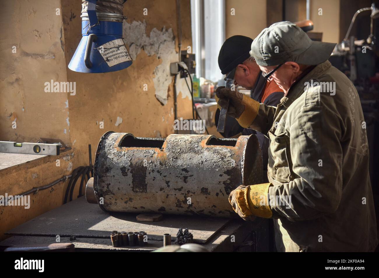 A worker of one of the Lviv utility companies makes a special metal ...