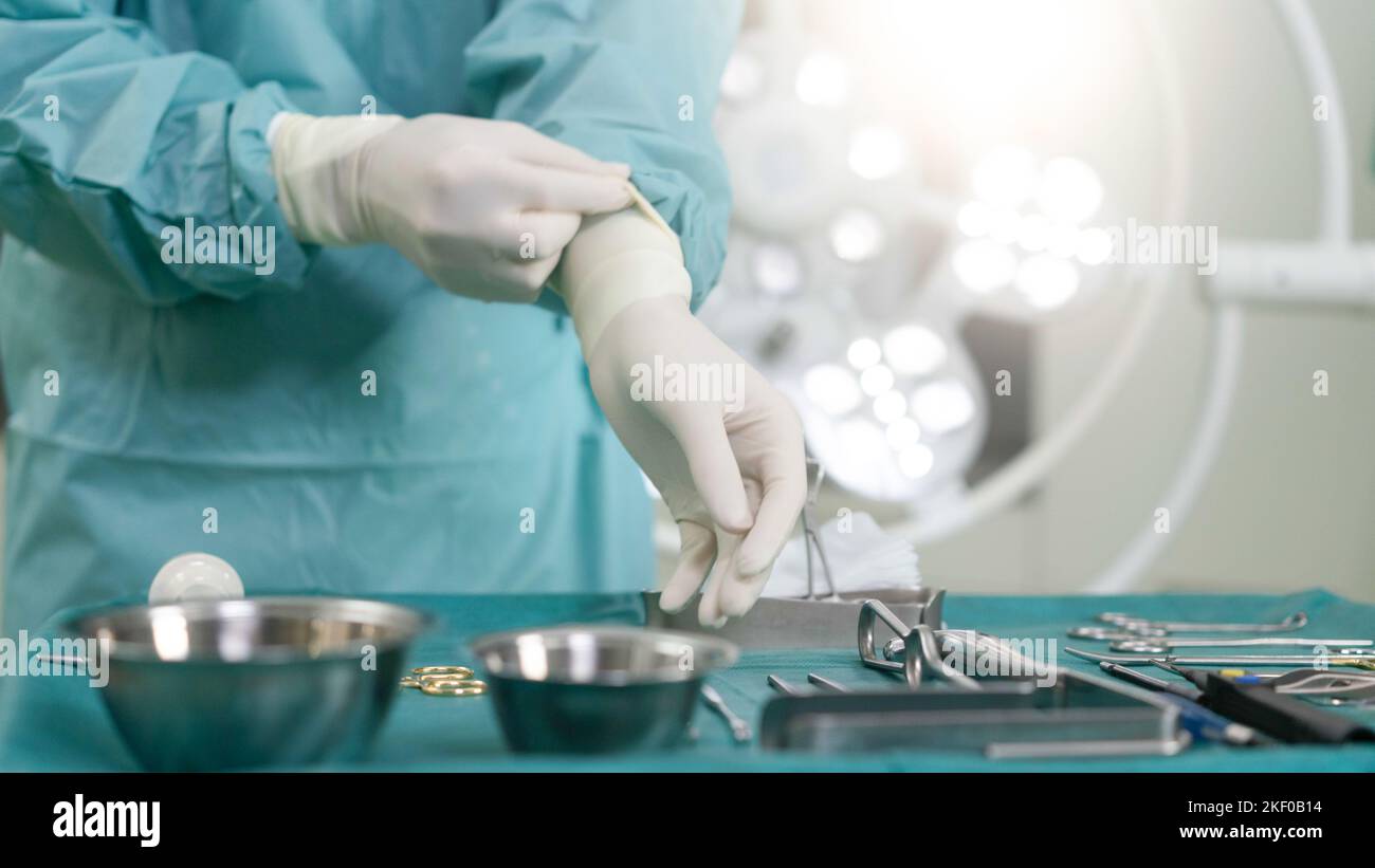 A closeup shot of a doctor with gloves using surgical instruments ...