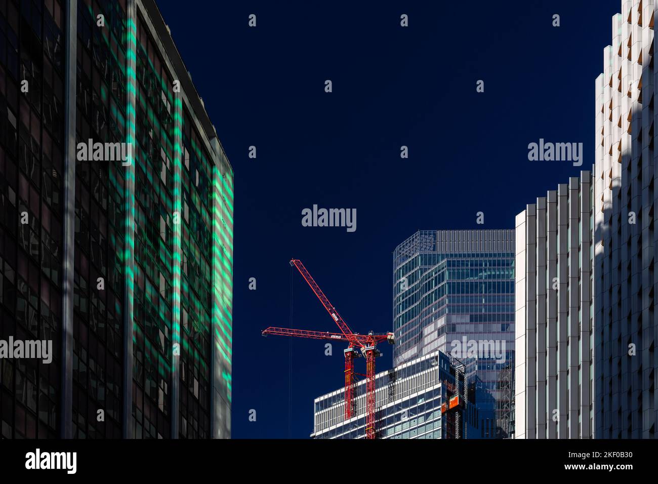 A stunning image of modern buildings against a dark blue sky.To the ...