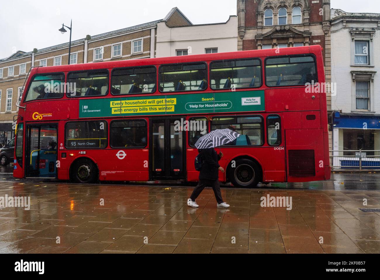 London UK. 15 November 2022. A pedestrian battles the wind and lashing ...