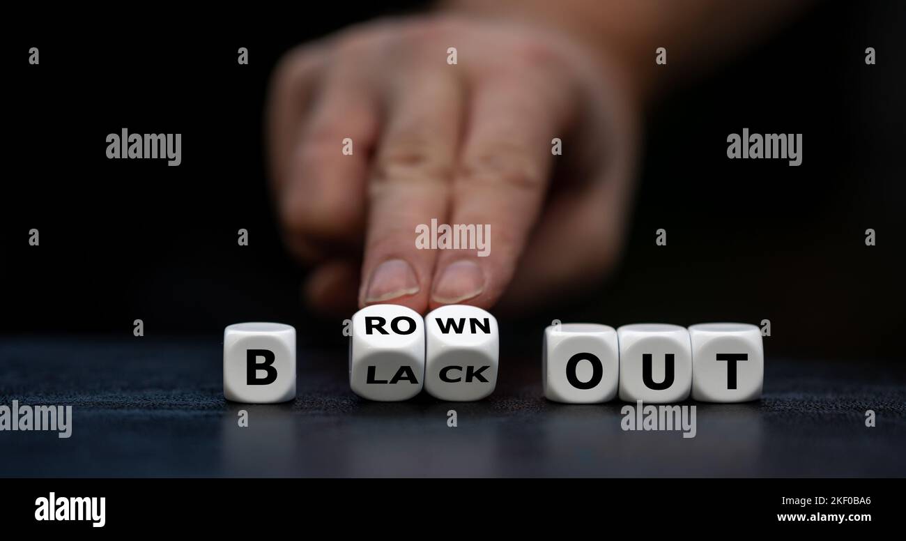 Hand turns dice and changes the expression 'blackout' to 'brownout ...