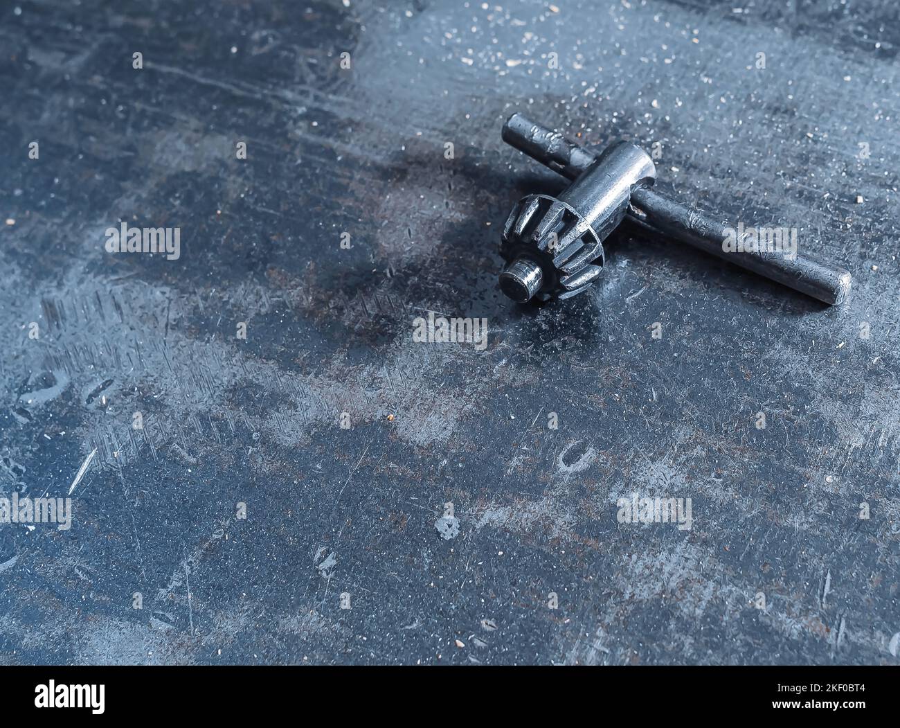Drill key on scratched metal background Stock Photo - Alamy
