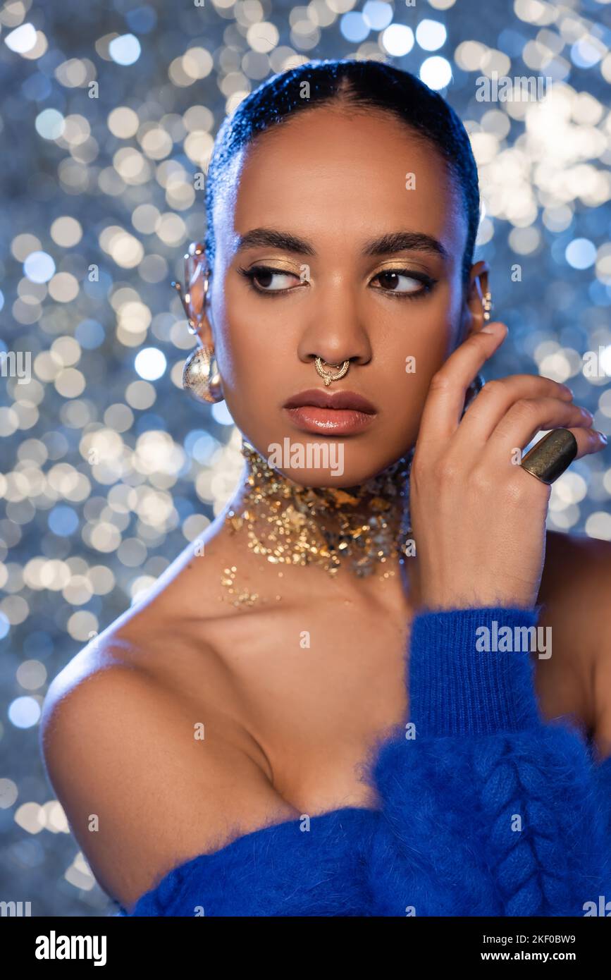 Portrait of trendy african american model with golden accessories ...