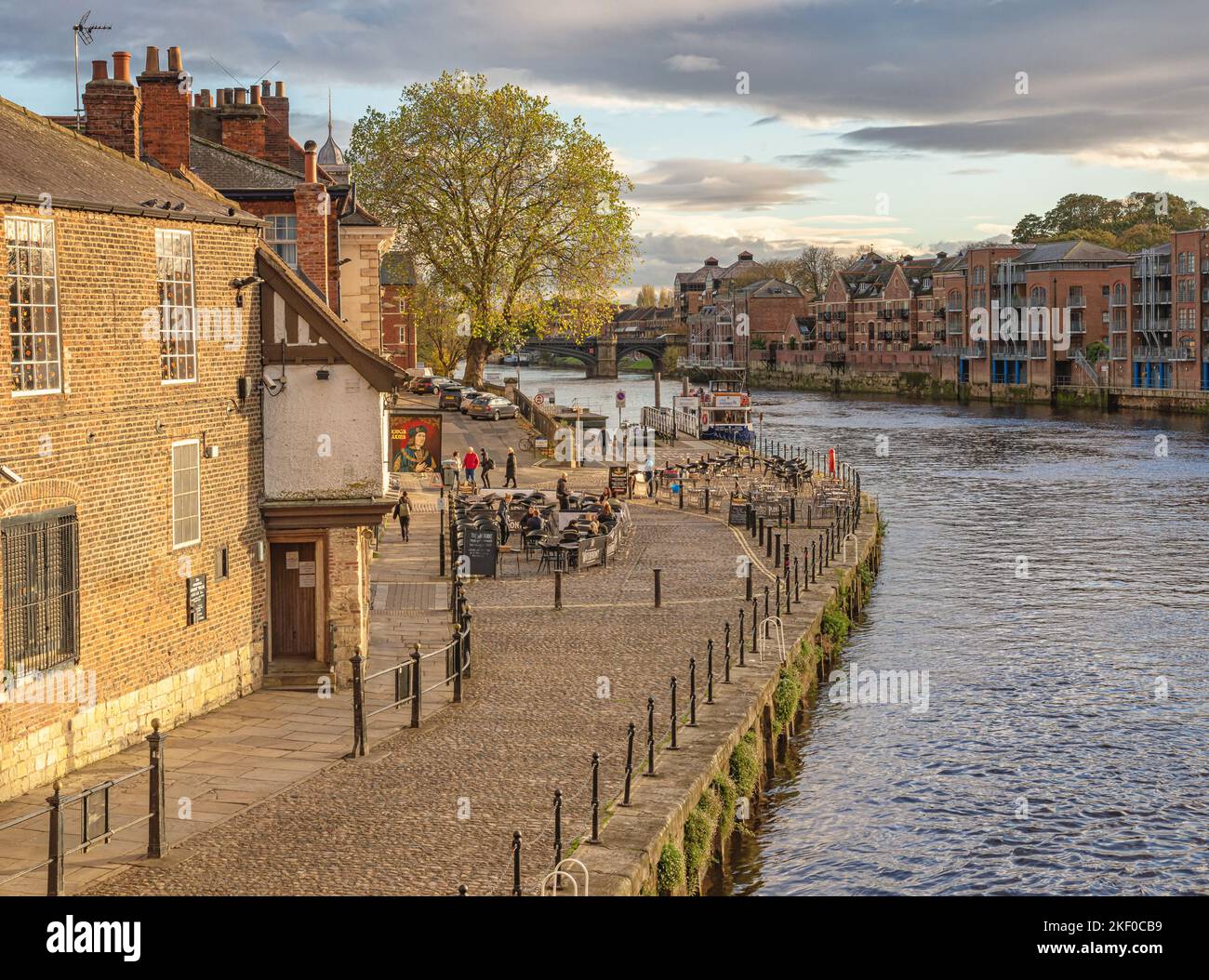 Riverside pub in York. The ancient building is beside a cobblestone ...