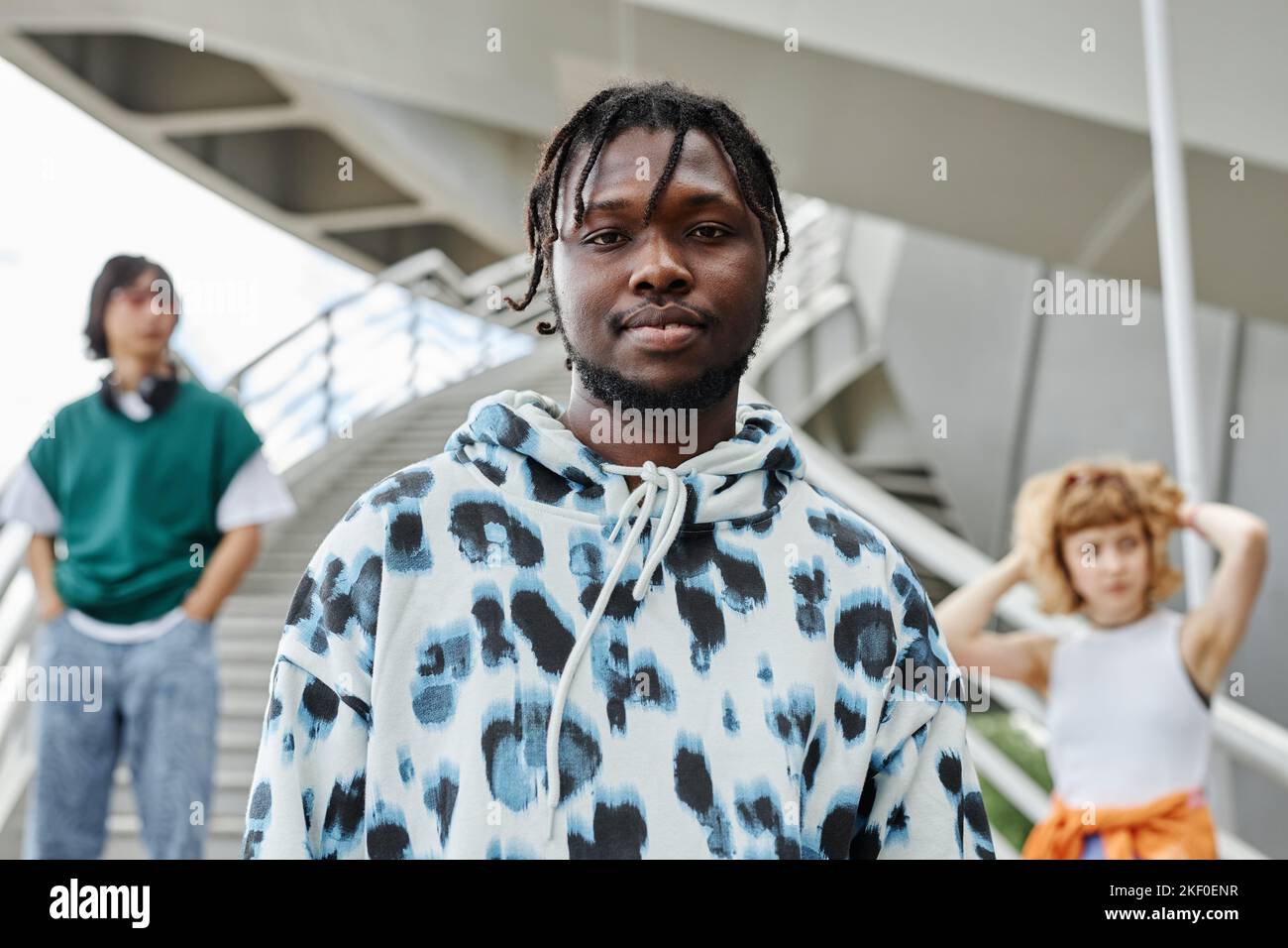 Diverse group of young people wearing street style clothes outdoors ...