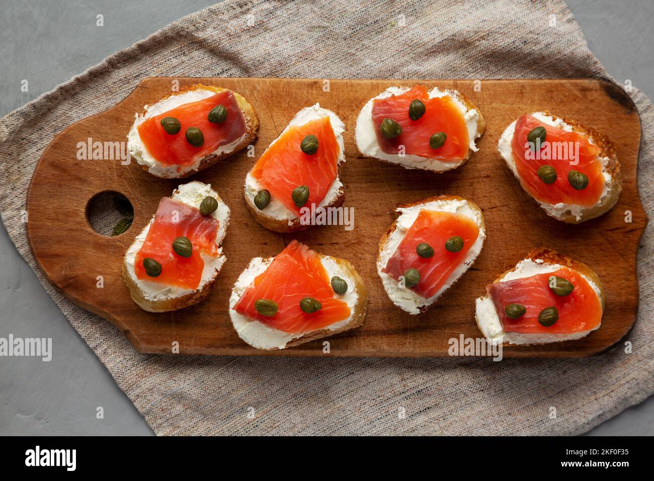 Homemade Lox And Cream Cheese Crostini on a wooden board, top view ...
