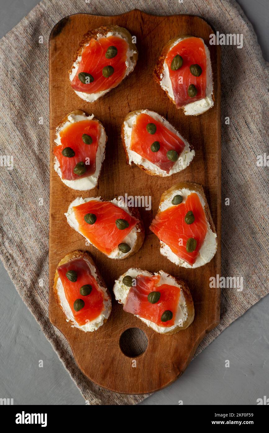Homemade Lox And Cream Cheese Crostini on a wooden board, top view ...