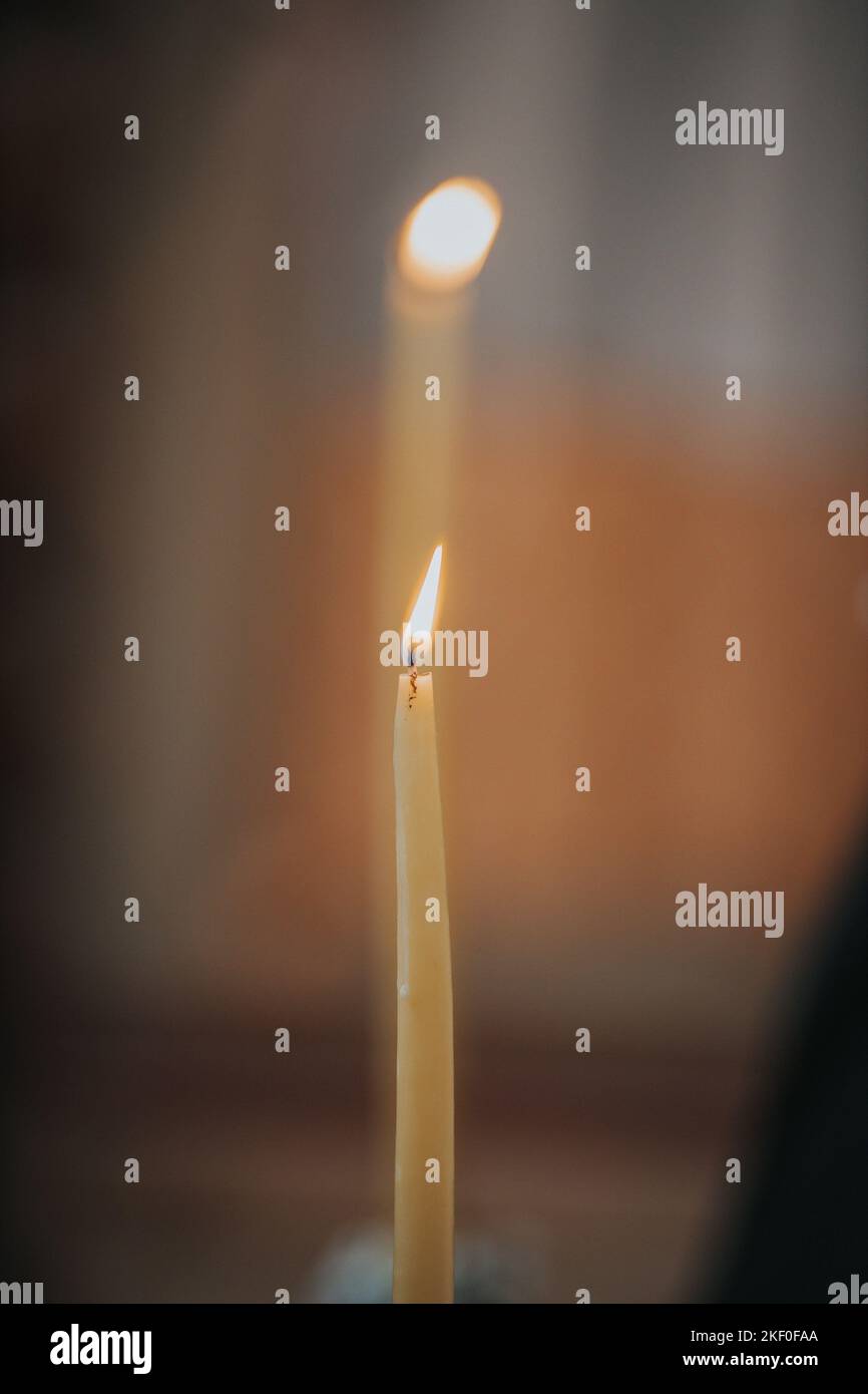 A closeup of burning candle isolated in blurred background Stock Photo ...