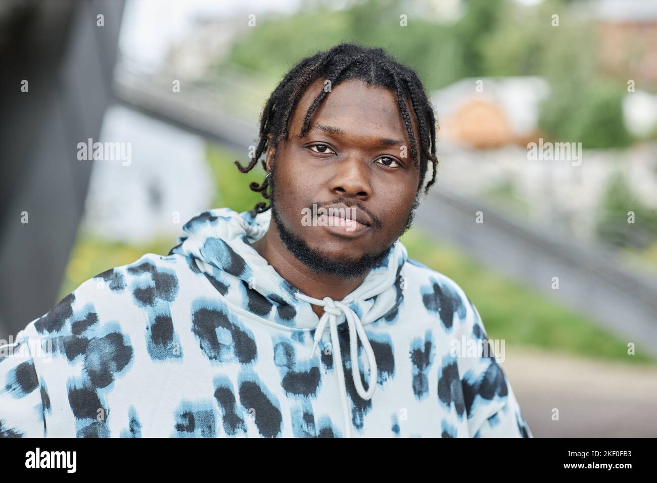 Portrait of young black man wearing leopard print hoodie outdoors and ...