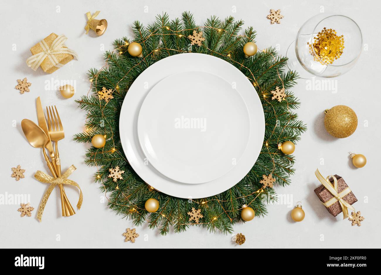 Christmas empty table setting with golden accessories on a gray ...