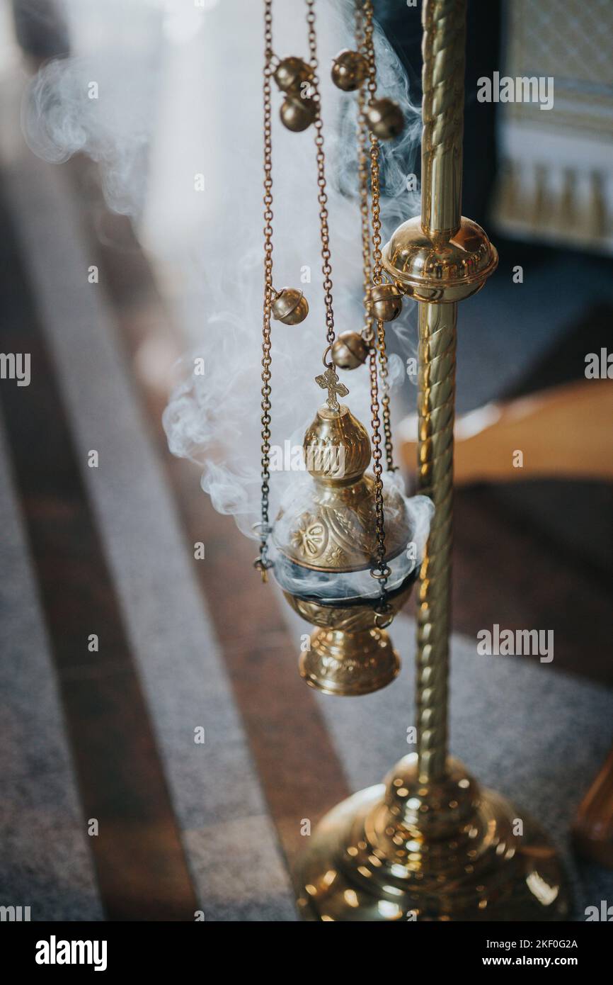 A censer hanging in the church with aromatic incense strewn on lighted ...