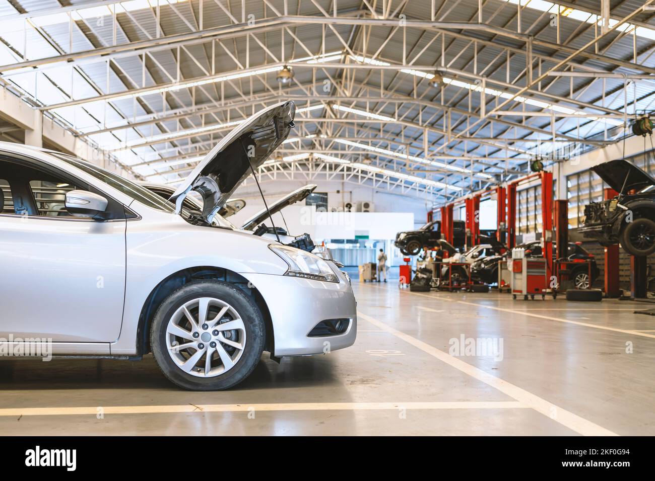 car in automobile repair service center with soft-focus and over light ...