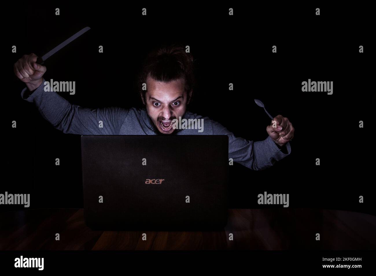 An angry male in front of his computer Stock Photo - Alamy
