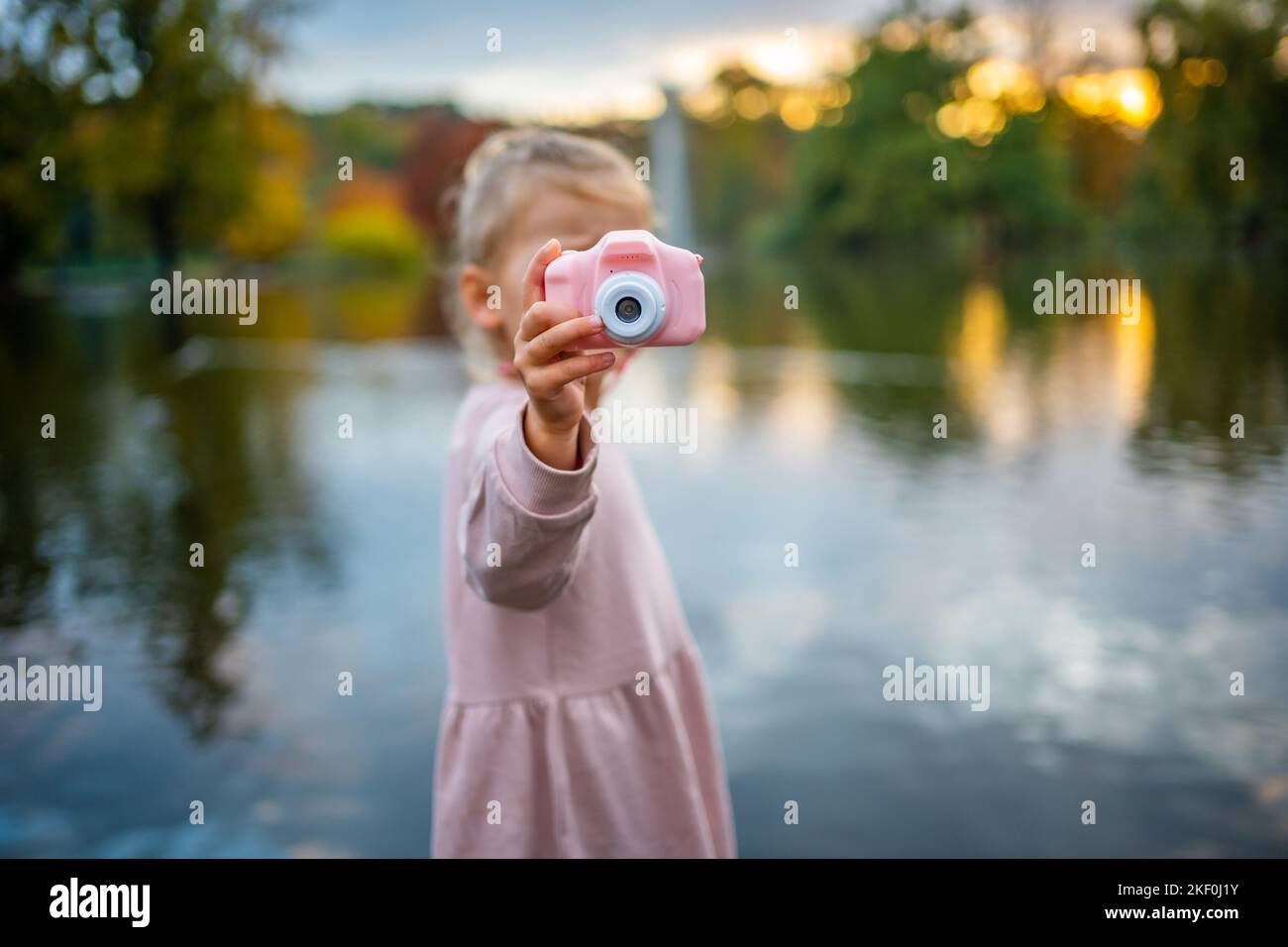 Toddler Girl Taking Pictures with Pink Digital Children's Camera in the ...