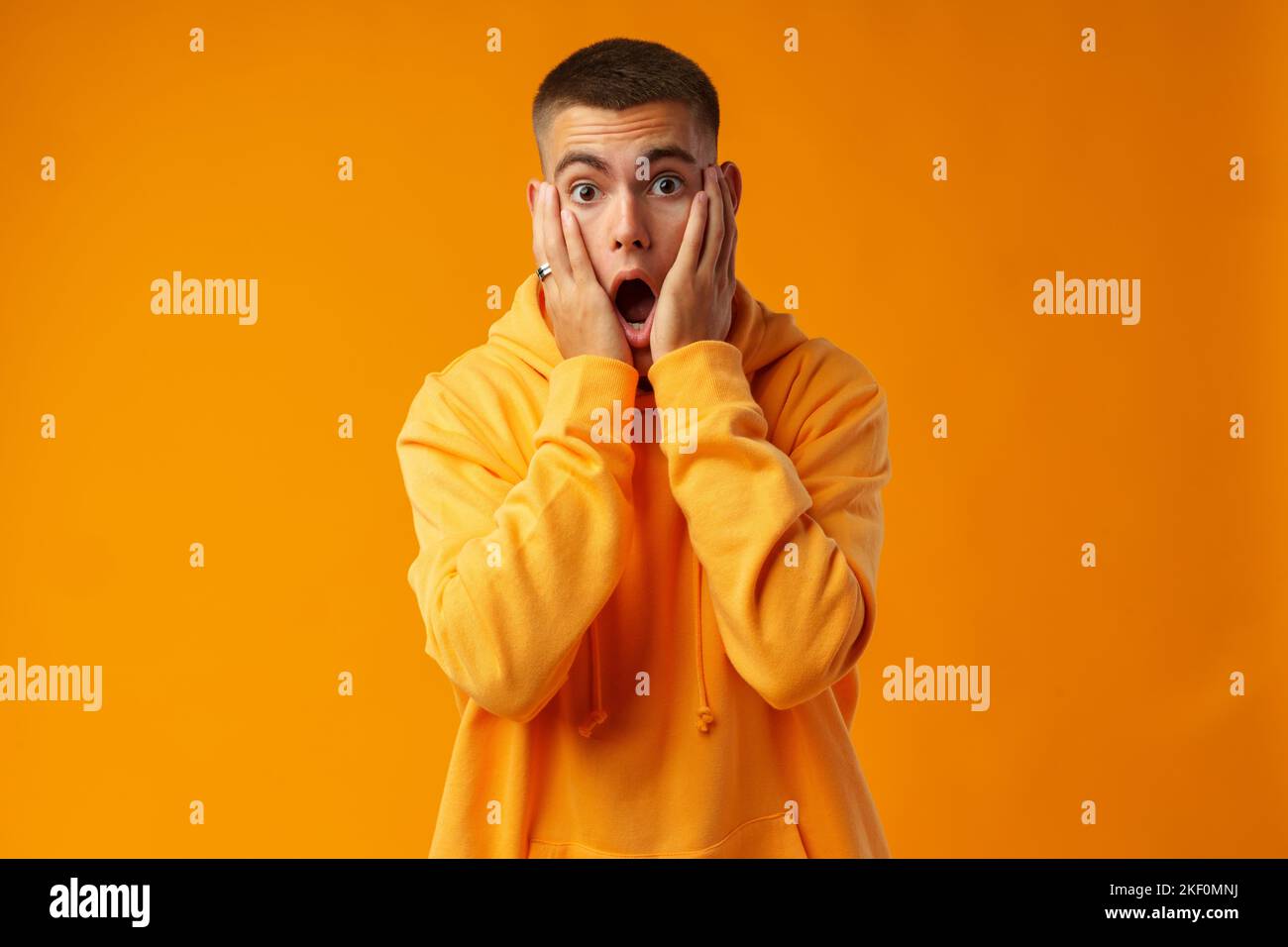 Young handsome man shocked with surprise expression standing over ...