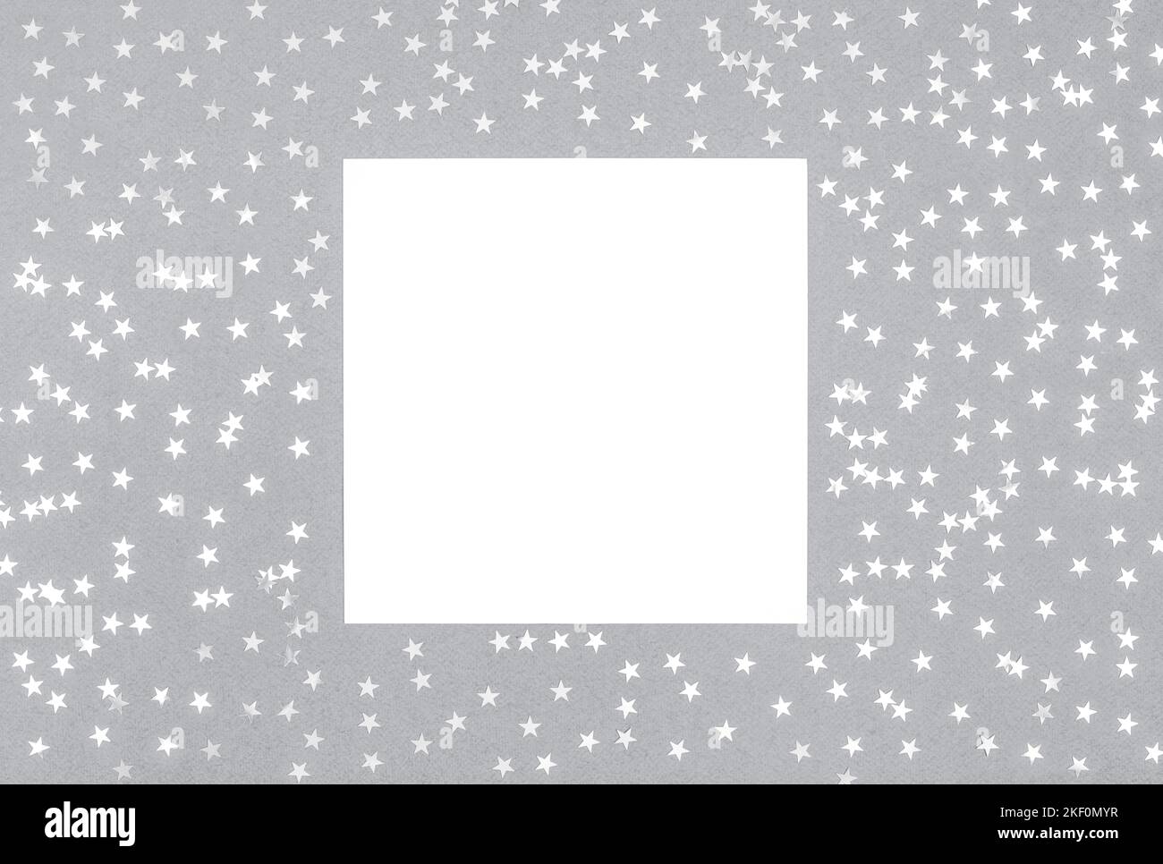 Blank template with silver confetti stars and white paper on a gray ...
