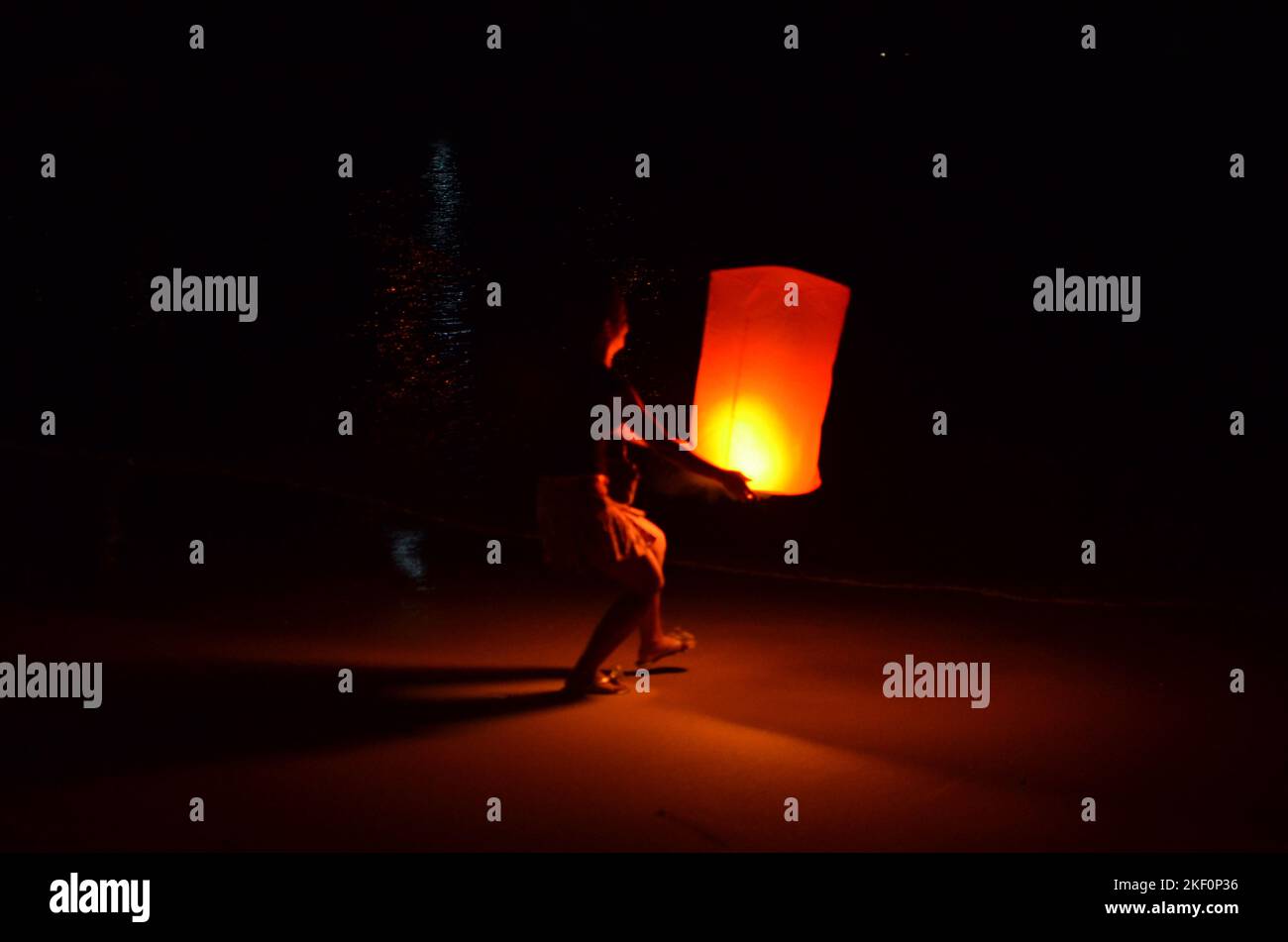 Starting a Floating Lamp Latern at beach in Thailand Stock Photo - Alamy