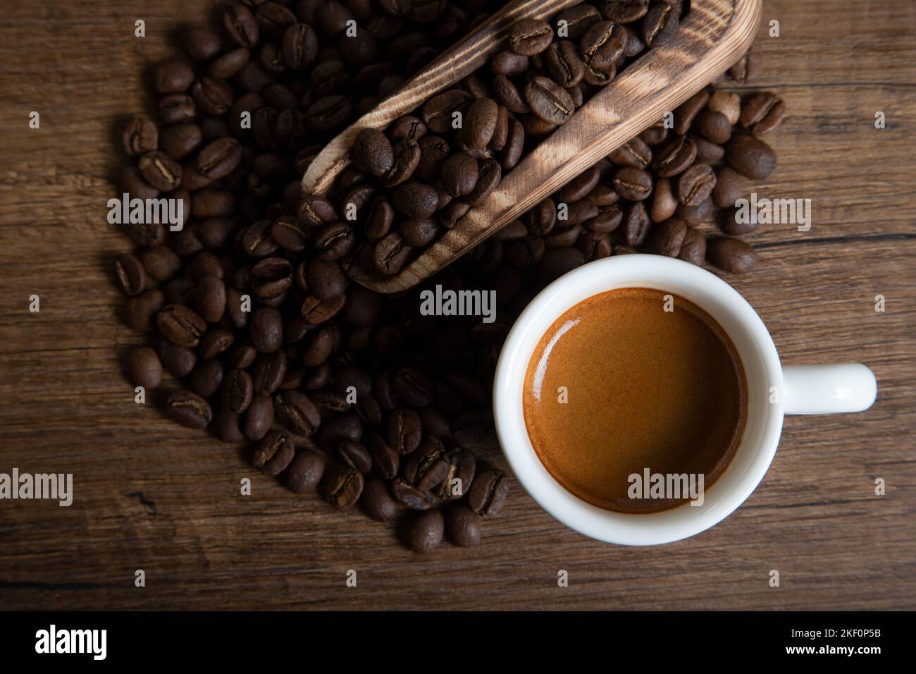Roasted coffee beans with a cup of espresso,top view Stock Photo - Alamy