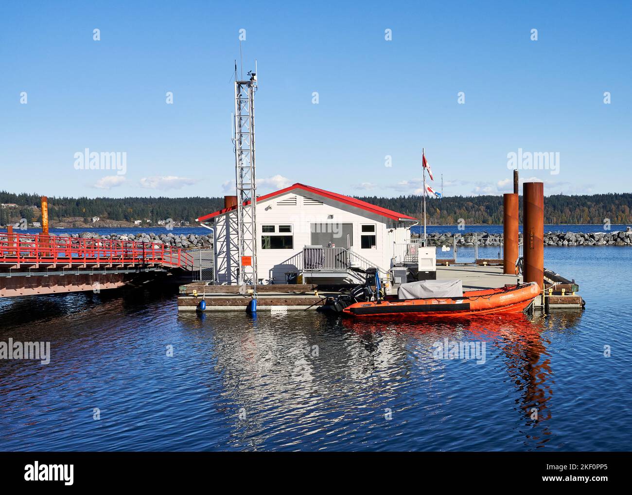 A red walkway to the floating Coast Guard building with a communication ...