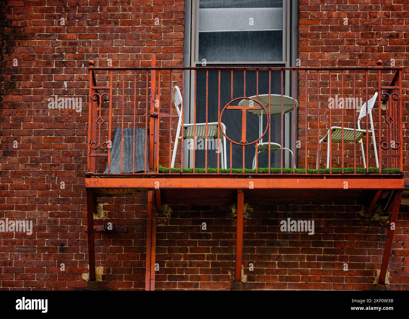 Small iron deck with chairs and table on a brick building Stock Photo ...