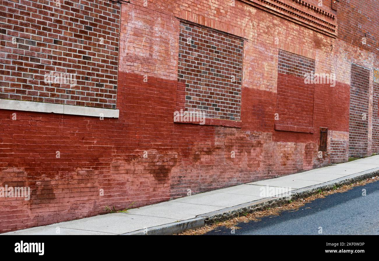A old brick building where windows have been removed and bricked up ...