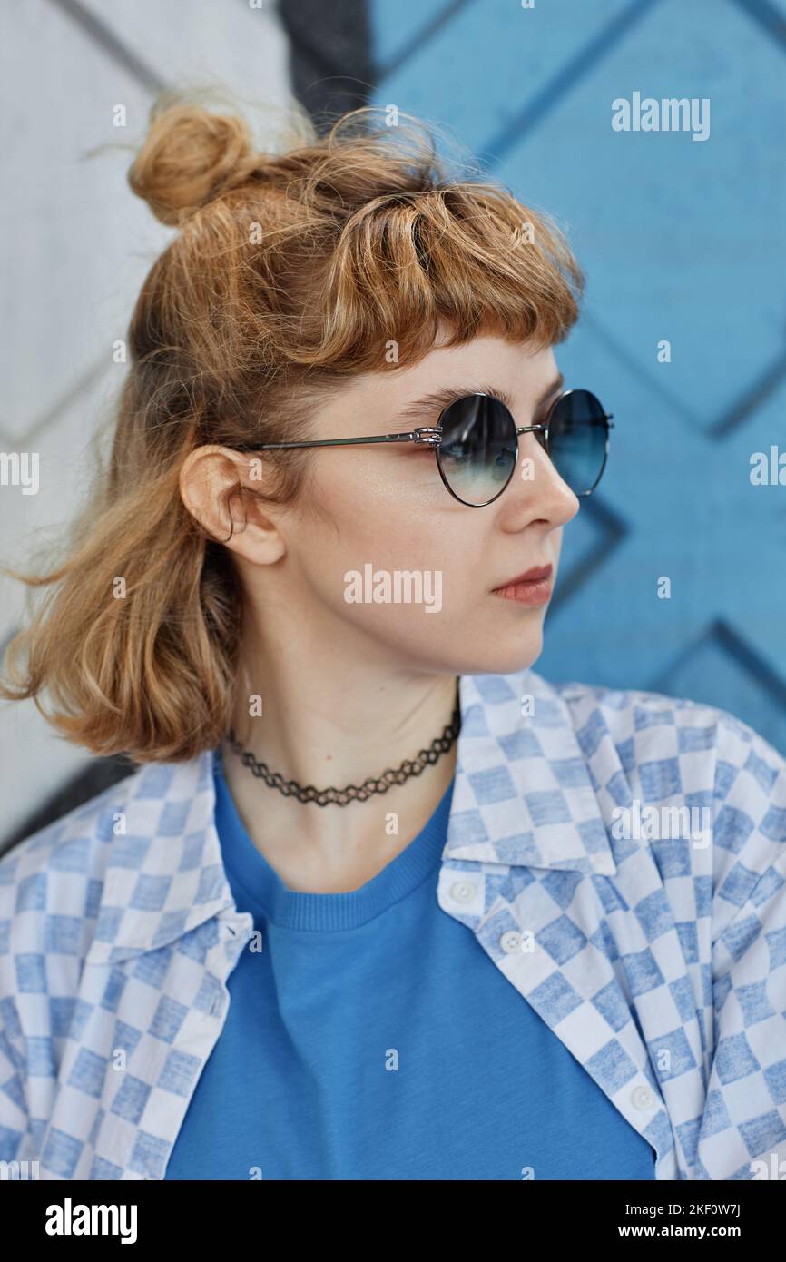 Vertical side view portrait of trendy young woman with curly hair ...