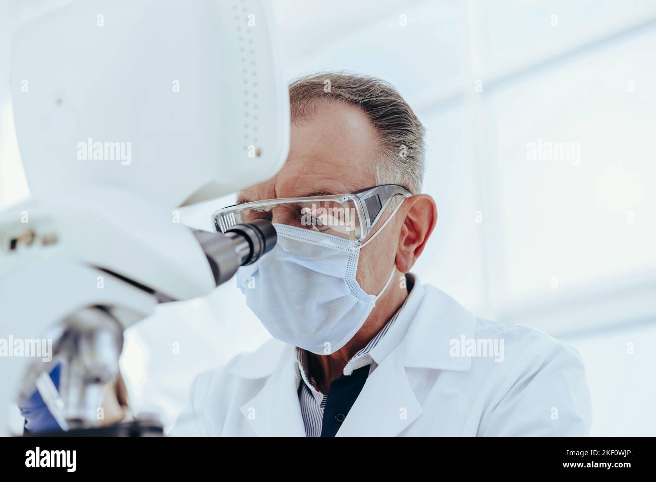 close up. a serious scientist using a laboratory microscope Stock Photo ...