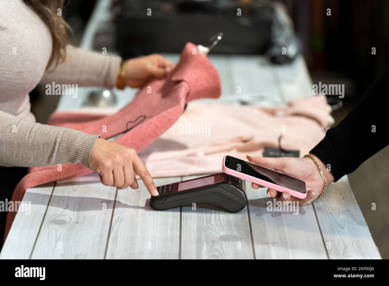 Close up woman paying smartphone store hi-res stock photography and ...