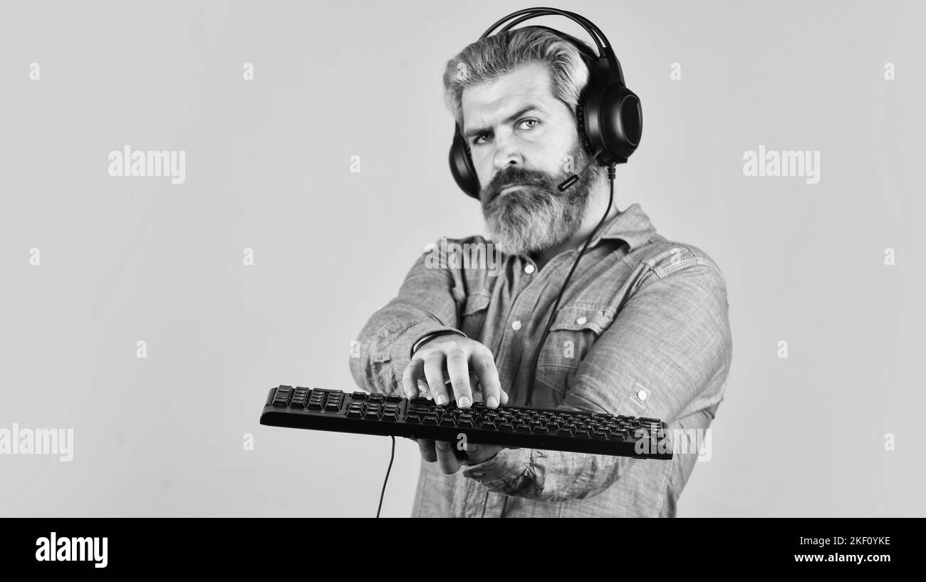 Gaming addiction. Man bearded hipster gamer headphones and keyboard ...