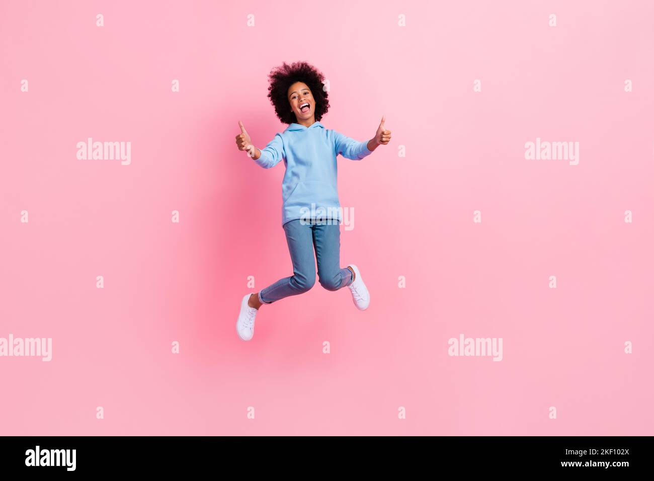 Full length portrait of excited crazy person jumping demonstrate thumbs ...