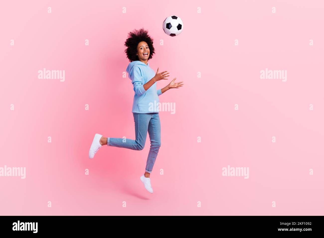 Full body portrait of sporty active little girl jump arms catch ...