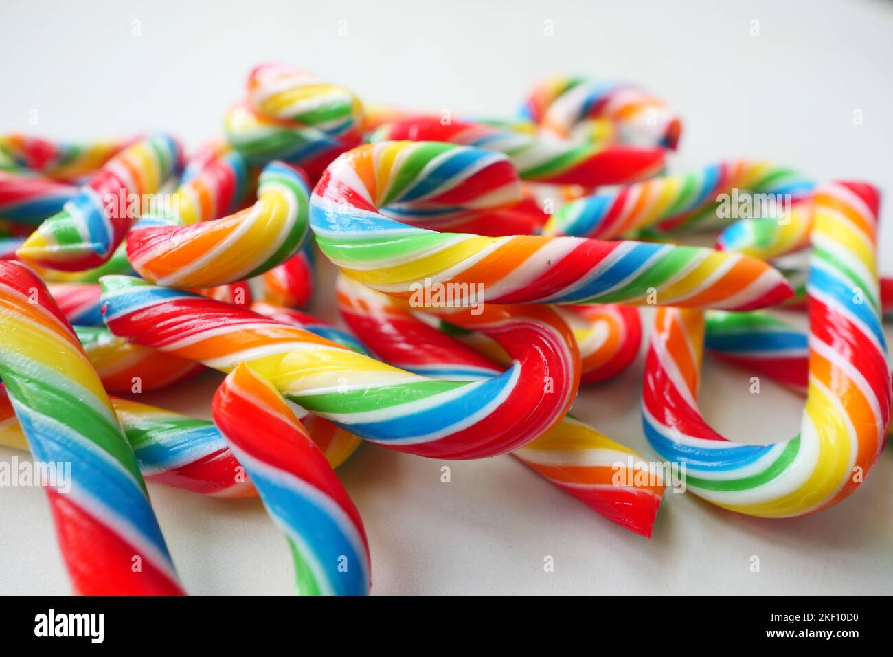 mini cherry candy canes on white background Stock Photo - Alamy