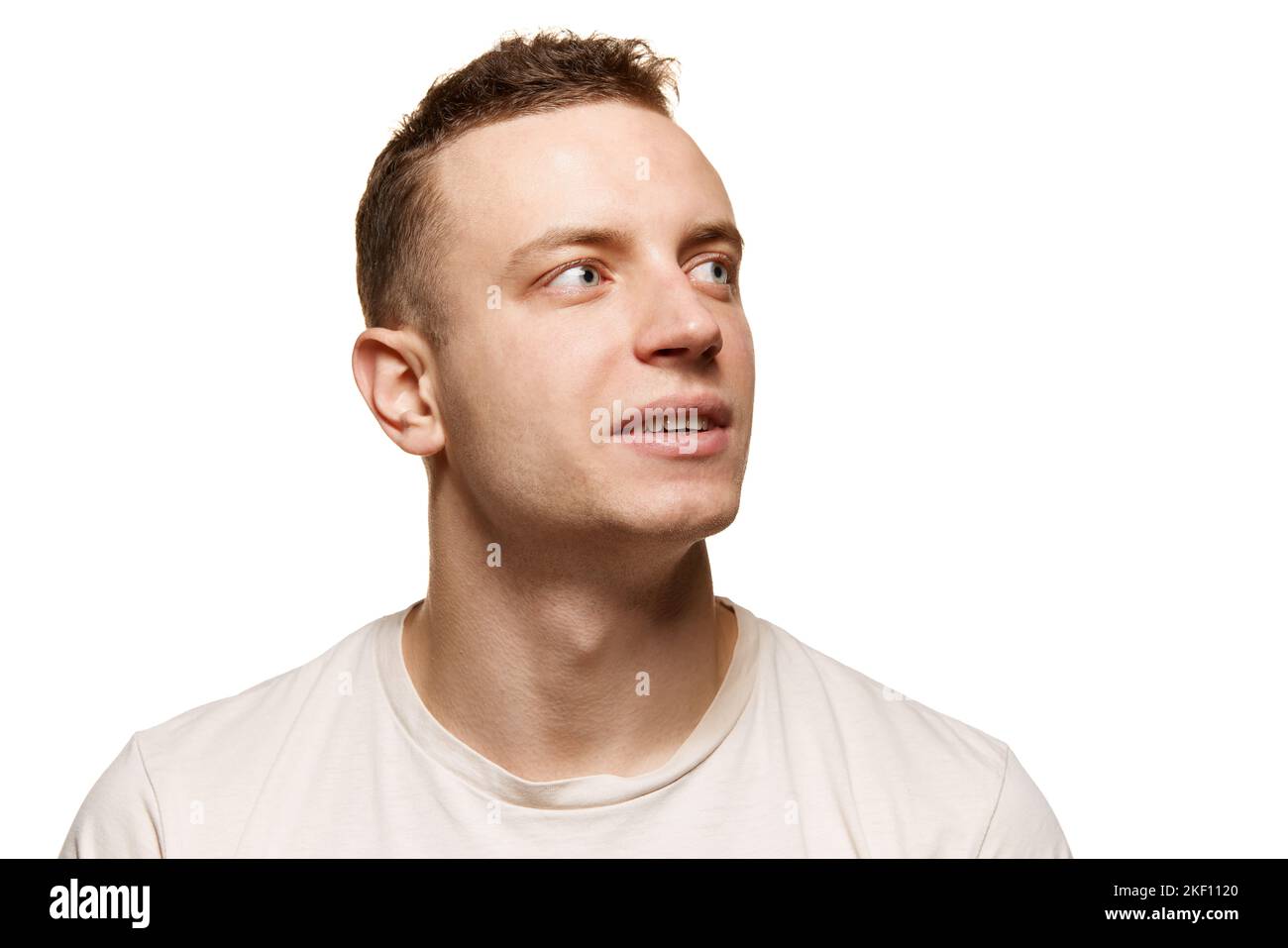 Portrait of young man with smooth shaved face, looking away isolated ...