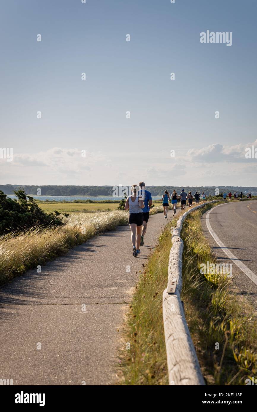A group of people running along a path on Marthas Vineyard Stock Photo ...