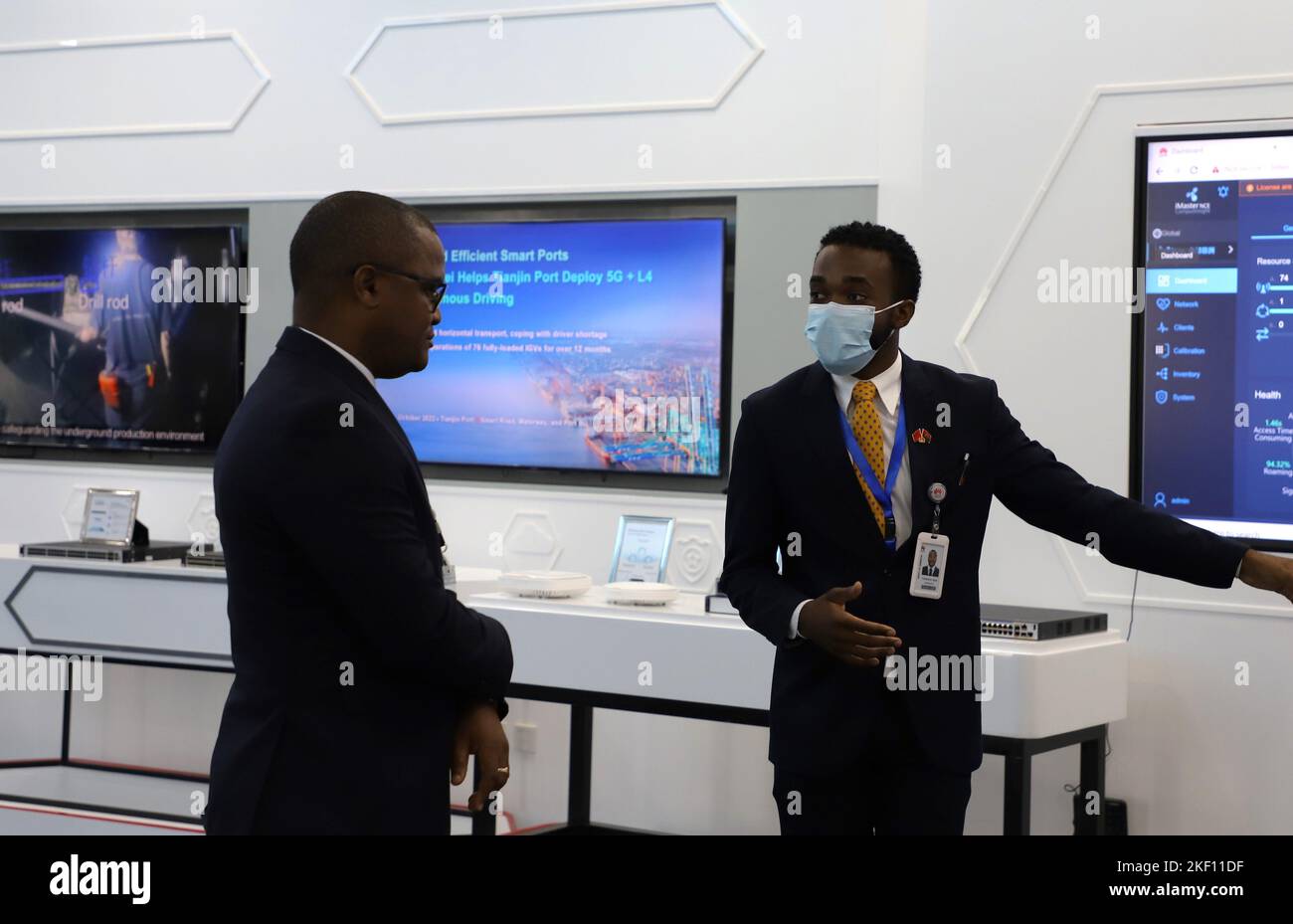 Luanda, Luanda. 14th Nov, 2022. Huawei's Angolan employee (R) presents products to a visitor at ...