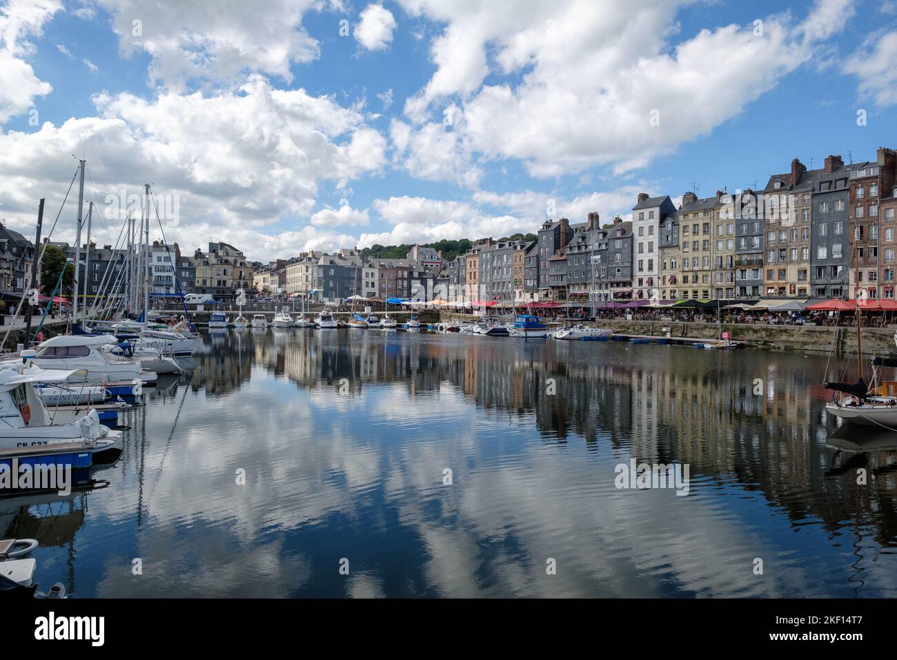 The harbour at Honfleur, Normandy, in Summer 2022, surrounded by cafes ...
