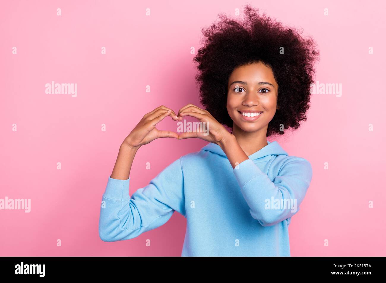 Portrait of cheerful positive girl hands showing heart gesture toothy ...