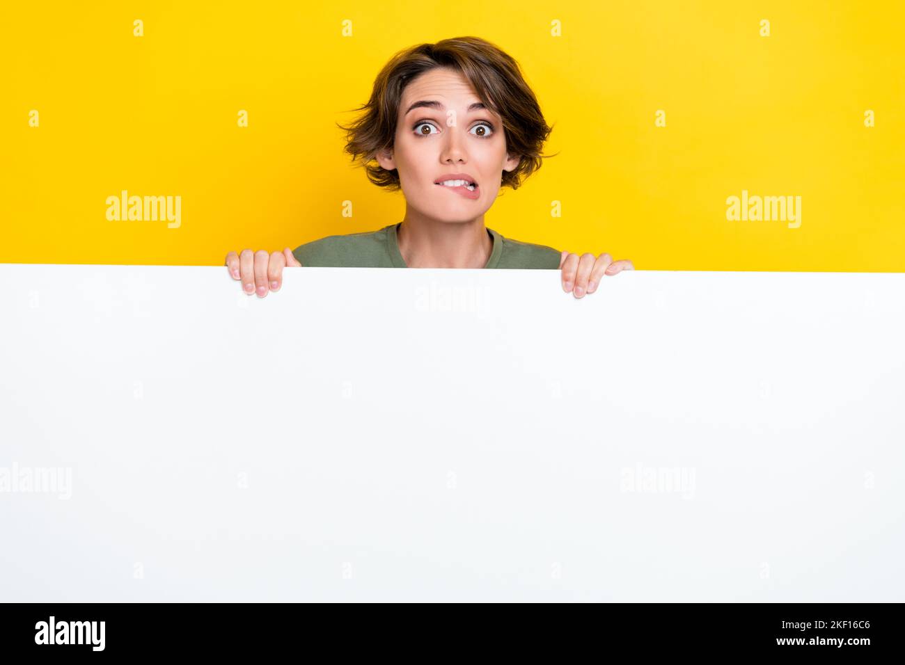 Photo of adorable pretty impressed woman bob hairdo khaki t-shirt hold ...