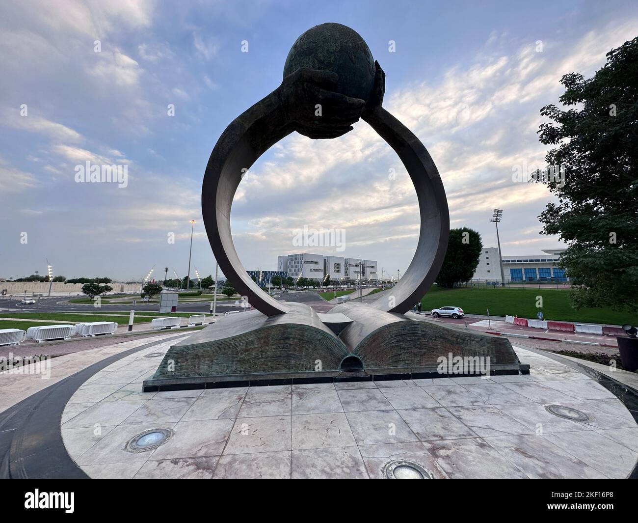 Hands rising from a book support the globe in this sculpture at Qatar's ...