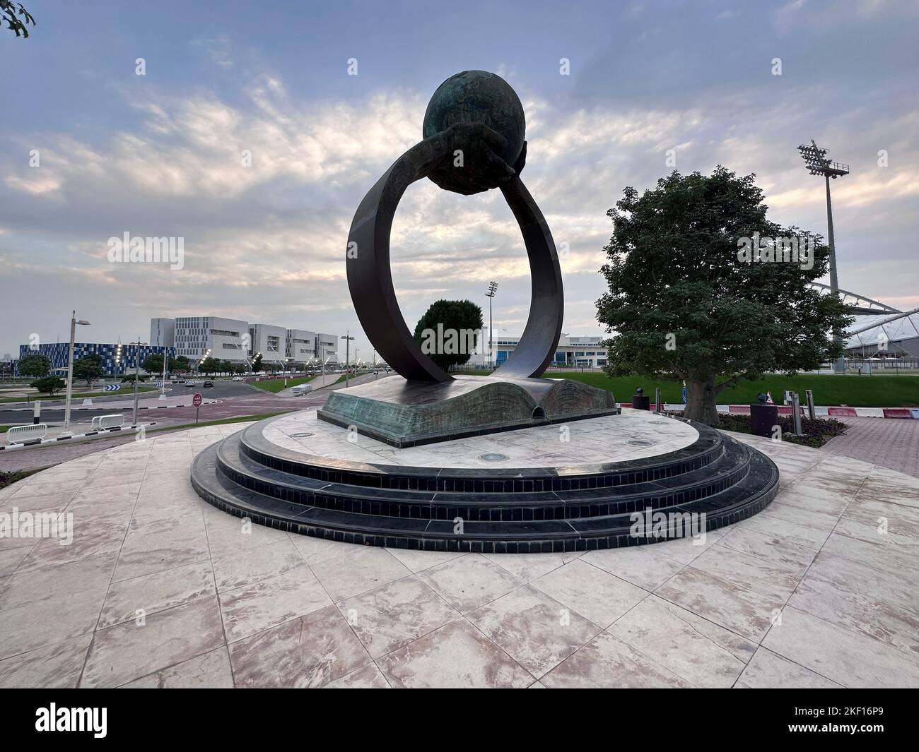 Hands rising from a book support the globe in this sculpture at Qatar's ...