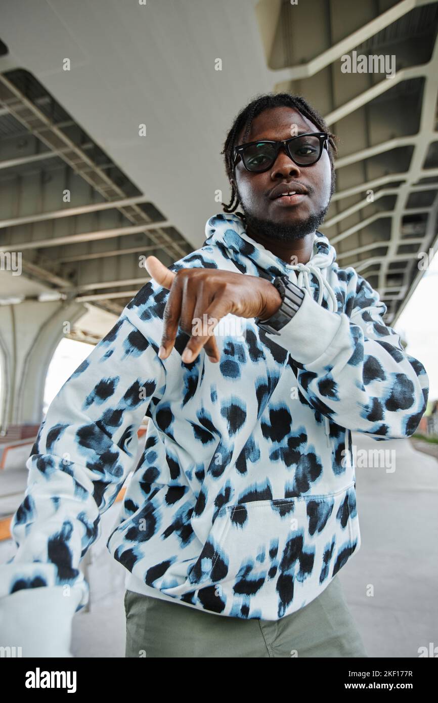 Vertical portrait of young black man dancing hip hop outdoors in urban setting Stock Photo - Alamy