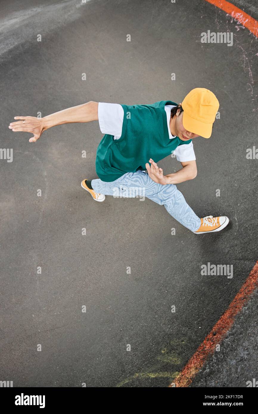 Graphic top view of young man dancing hip hop outdoors and wearing ...