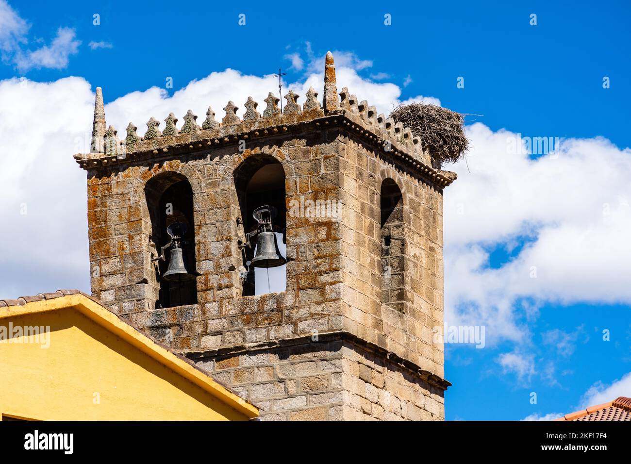 Old church tower with stork nest. View against blue sky. Avila, Spain ...