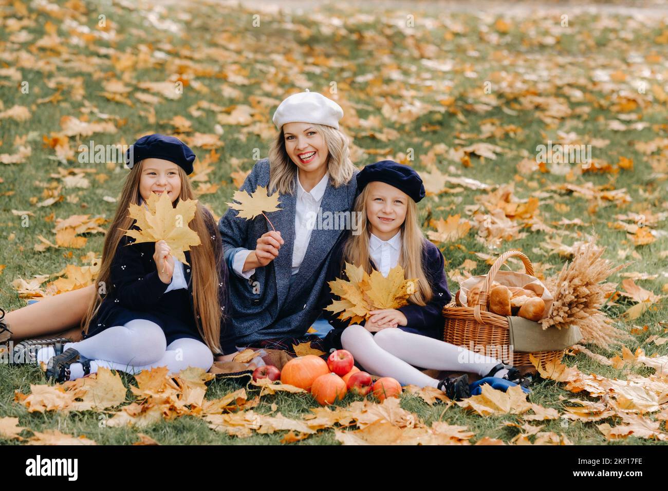 A big family on a picnic in the fall in a nature park. Happy people in ...